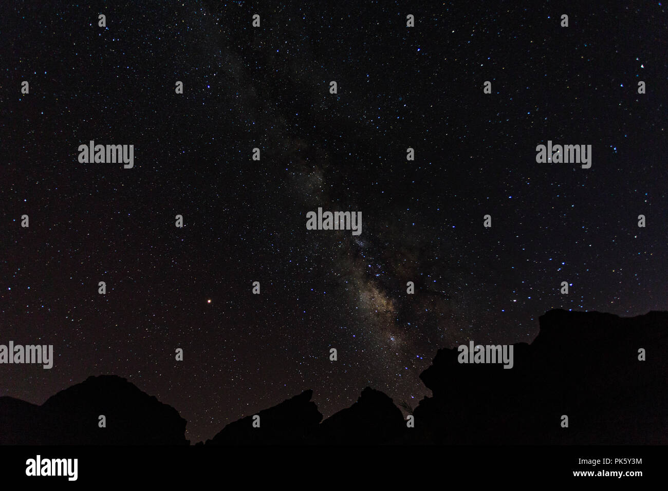 Galactic core of the milky way galaxy over the volcanic landscape of ...