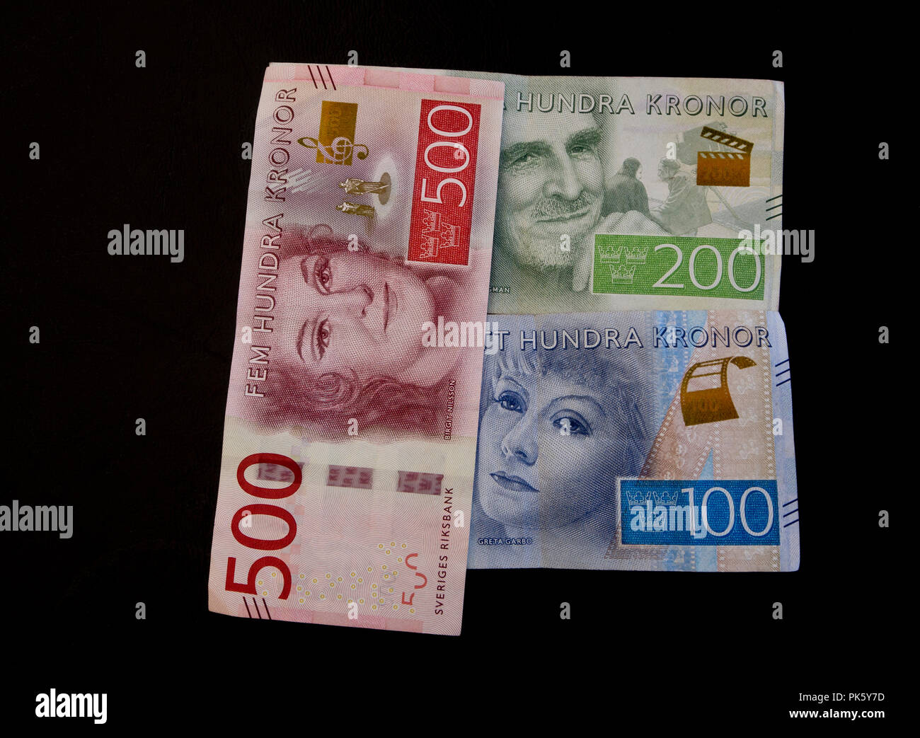 Swedish currency bank notes depicting famous Swedes on black background ...