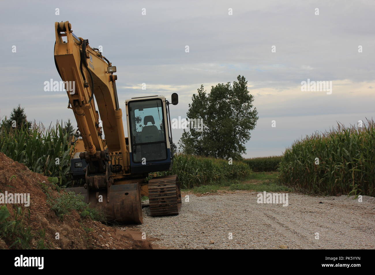 Construction crane at the corn field during late summer in rural ...