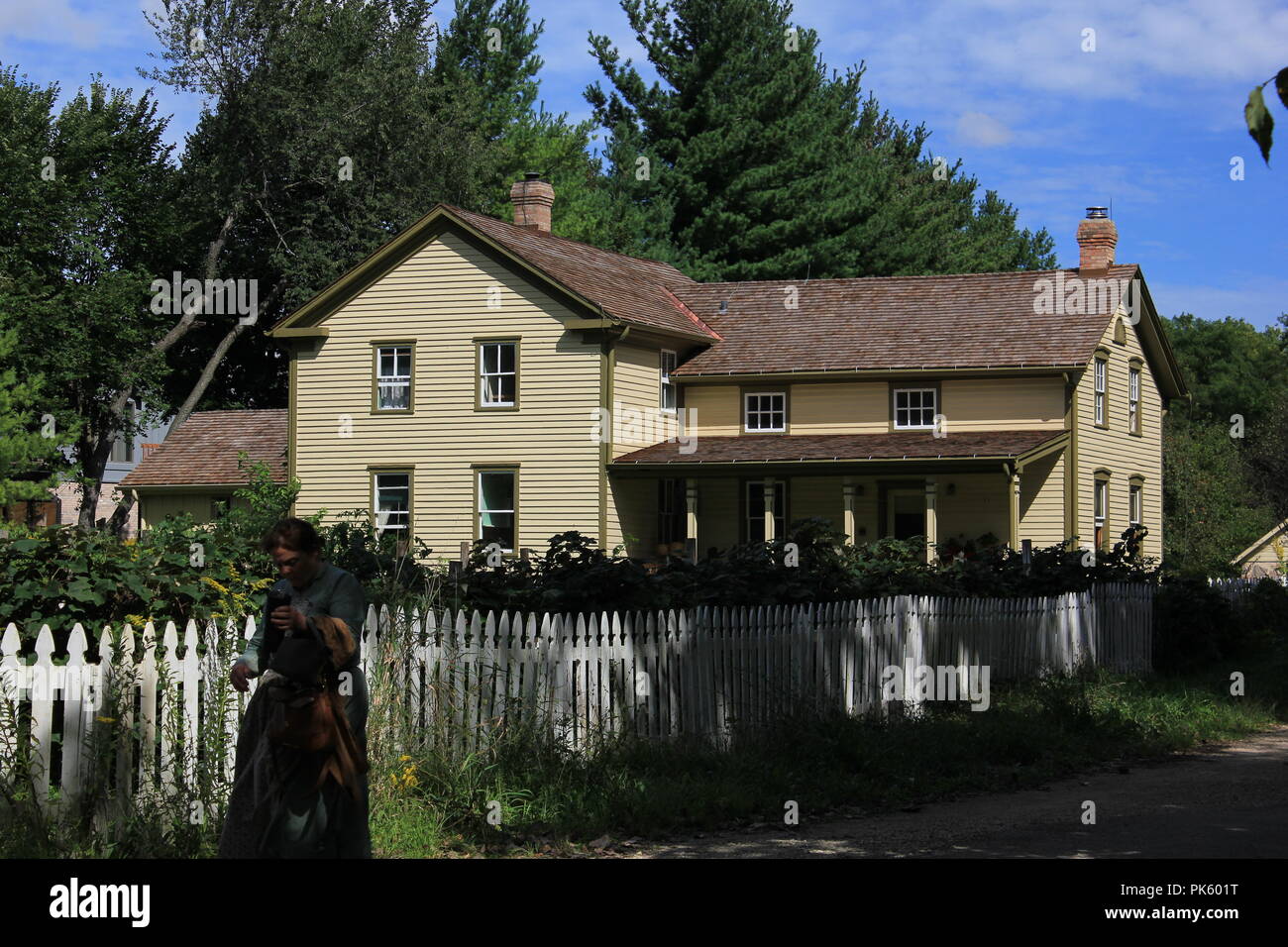 Main farmhouse and a person in period clothes at the farm on a late ...