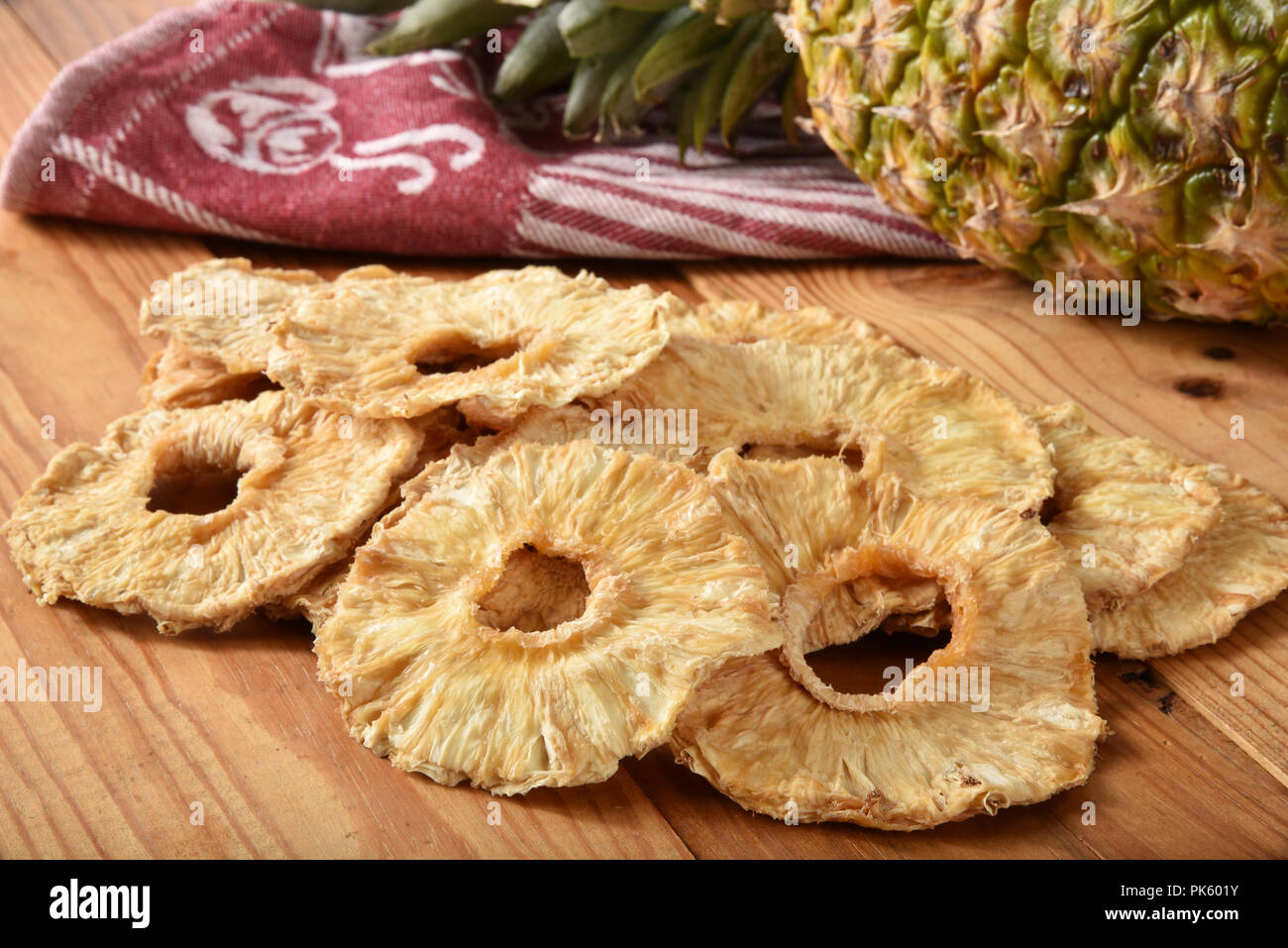 Slices of dried pineapple on a rustic wooden counter Stock Photo - Alamy