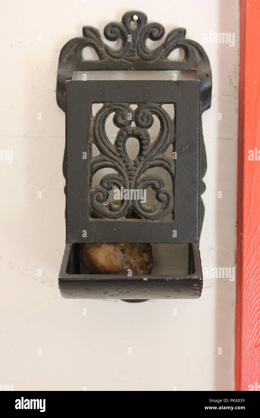 Wall mounted cast iron receptacle and holder on a late summer day Stock ...