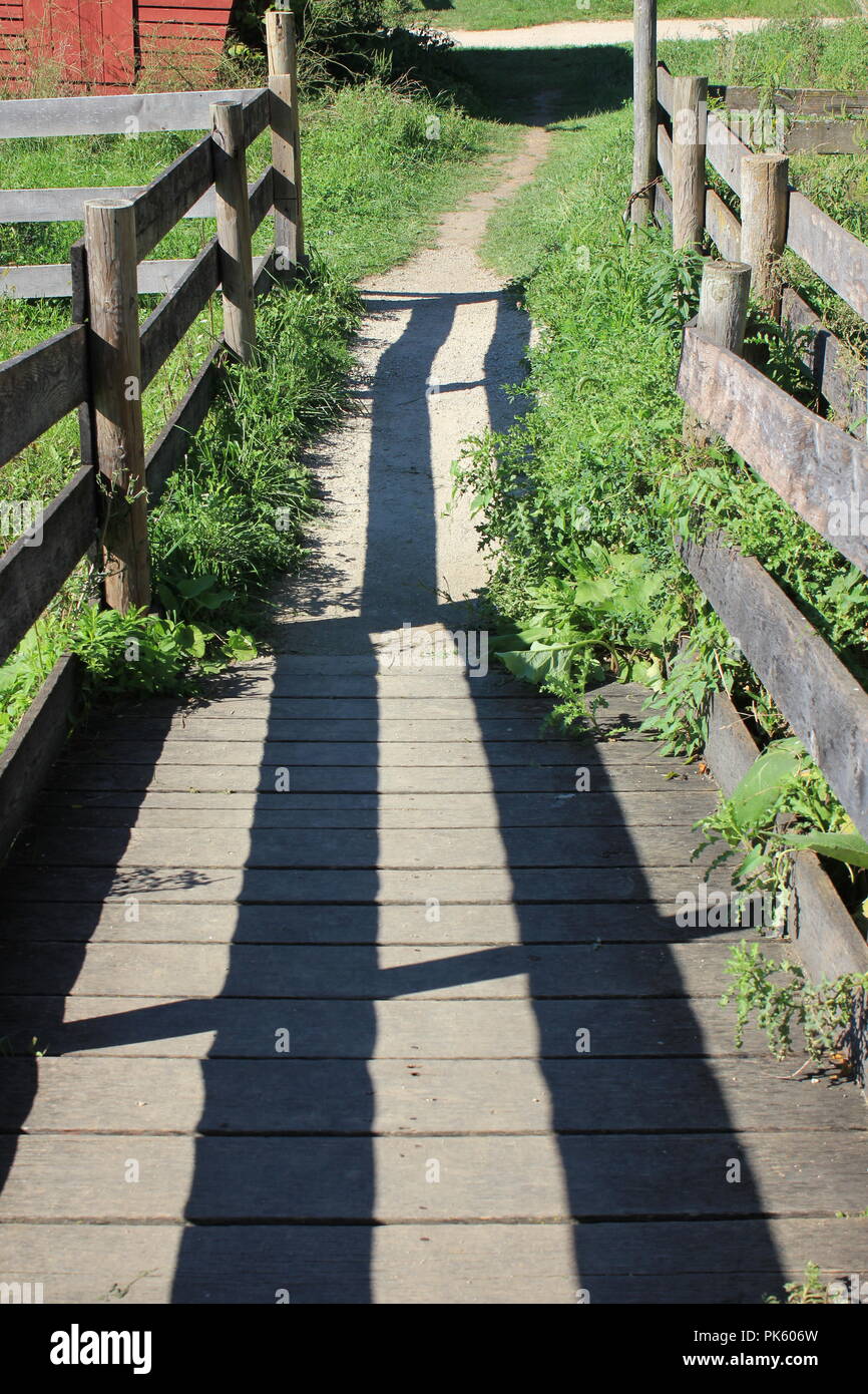 Wood boardwalk leading into a dirt path at the Volkening Heritage Farm ...
