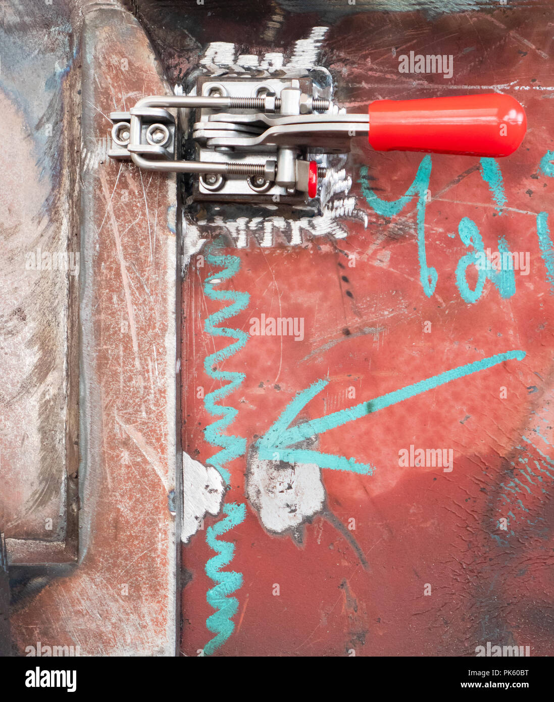 Clamp on door of unfinished machine at a workshop Stock Photo - Alamy