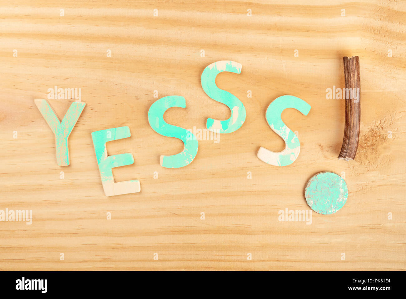 Yes, painted letters forming the word on a wooden background with copy ...