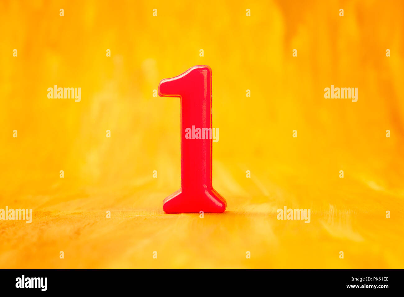 A photo of a red number one on a golden background with a place for ...