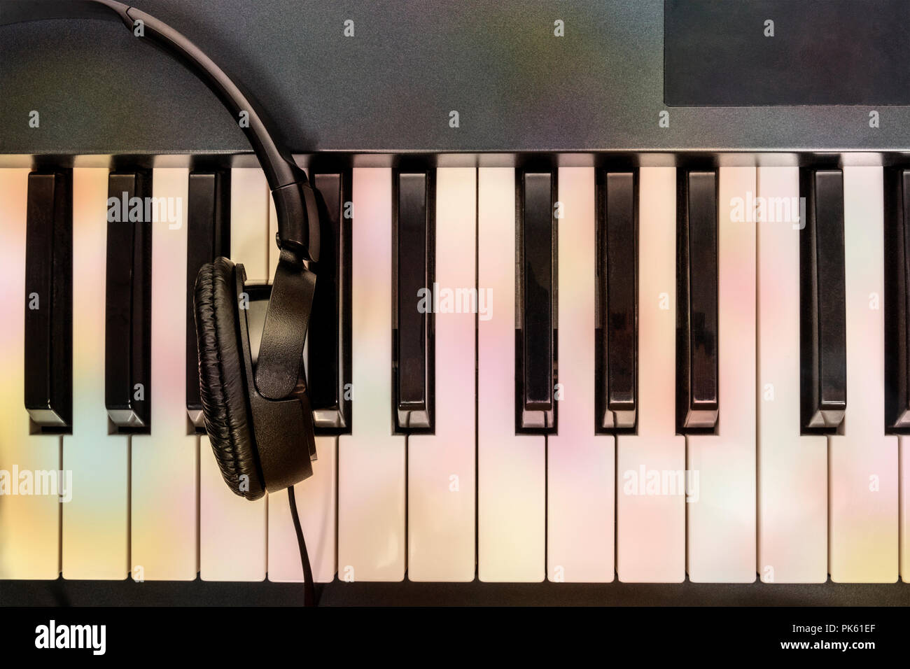 An overhead photo of piano keys with headphones, recording music, toned ...