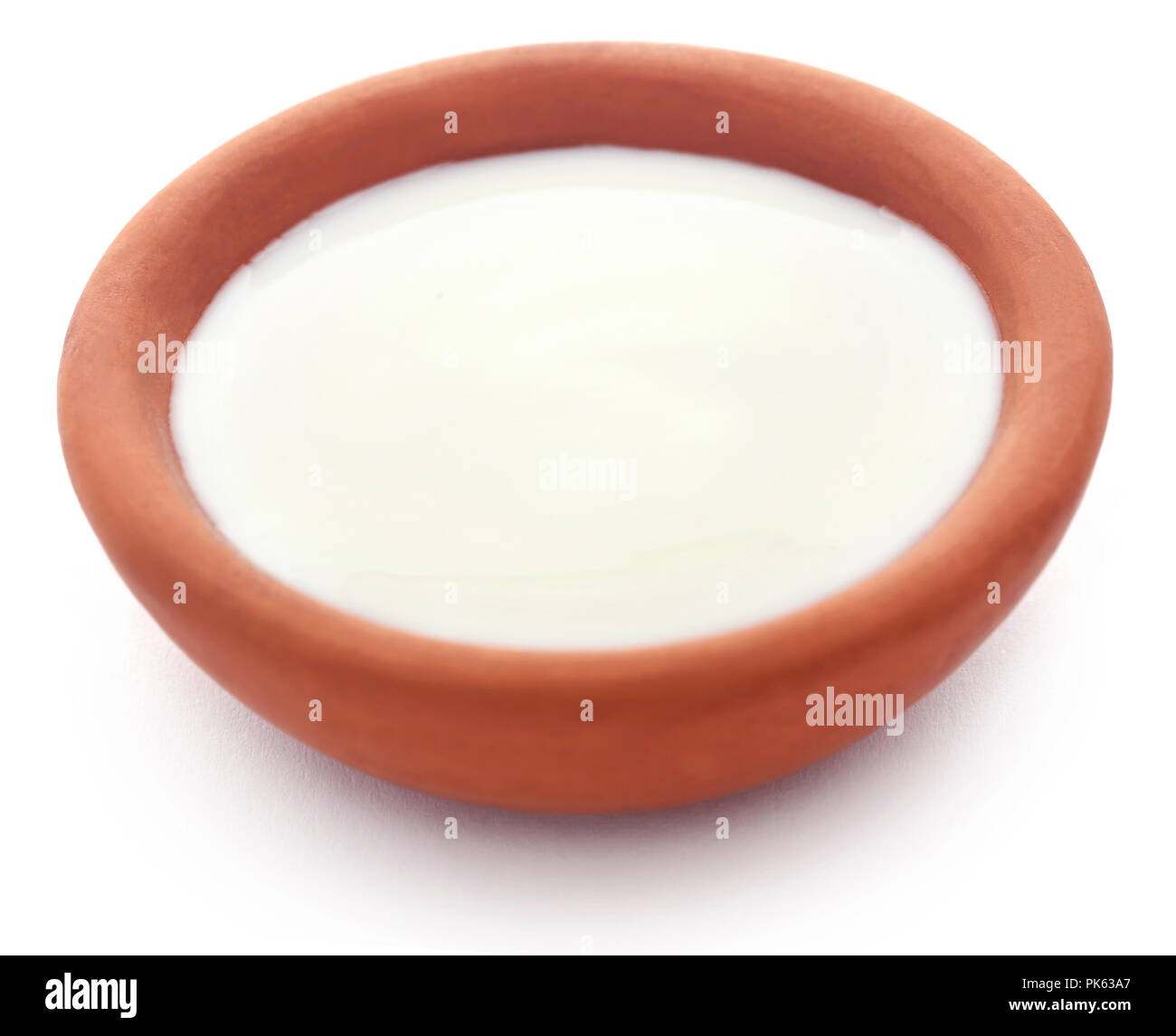 Fresh milk in a clay pottery over white background Stock Photo - Alamy