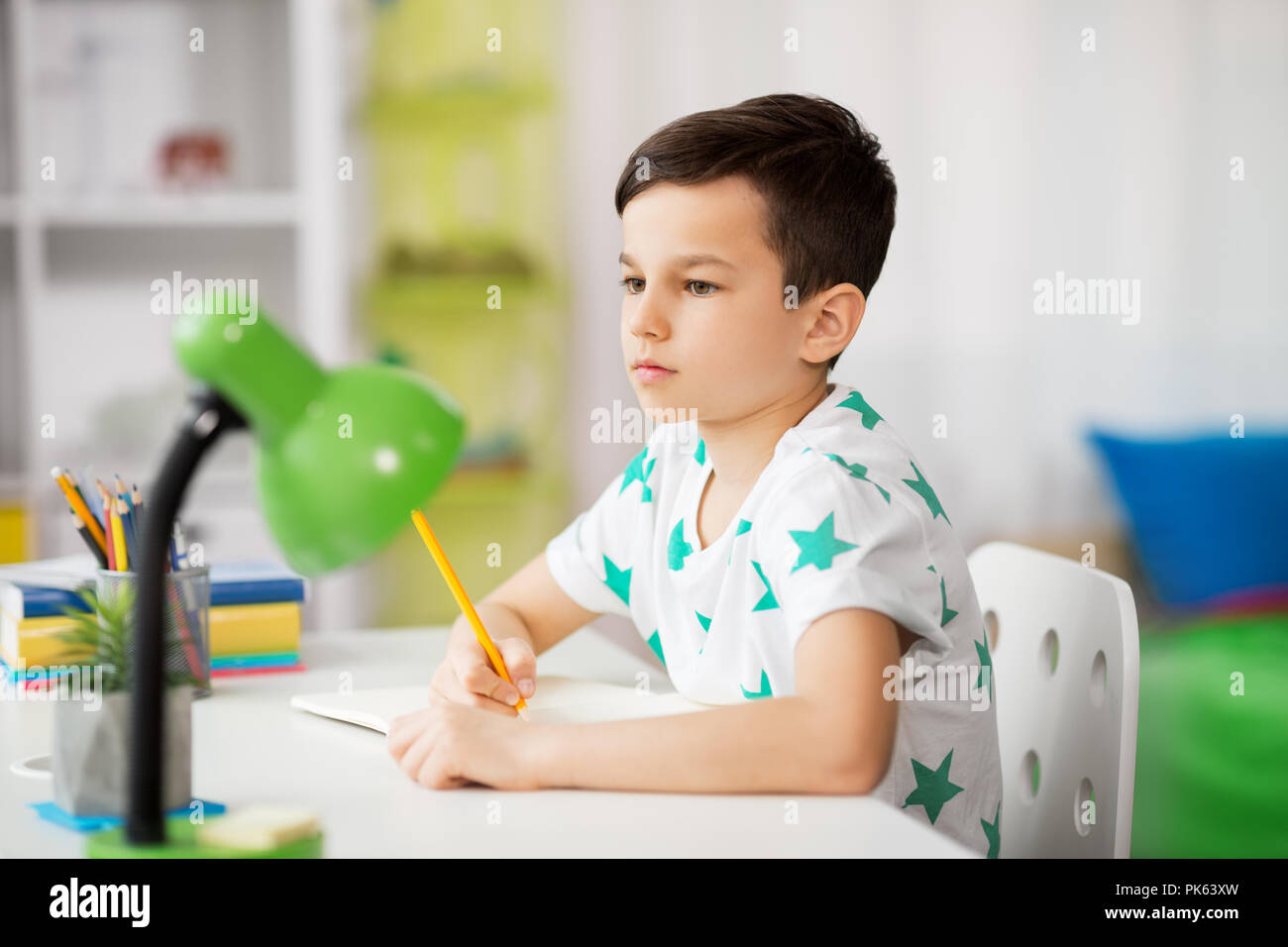 little boy writing to notebook at home Stock Photo - Alamy