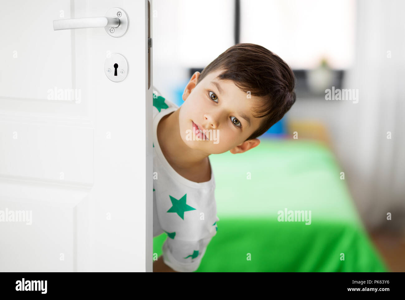 little boy behind door at home Stock Photo - Alamy