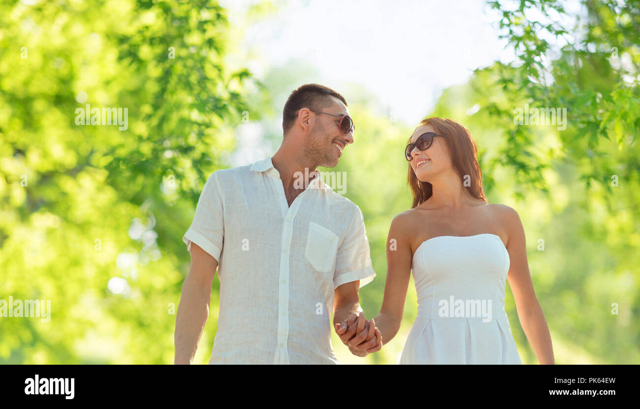 happy couple holding hands over natural background Stock Photo - Alamy