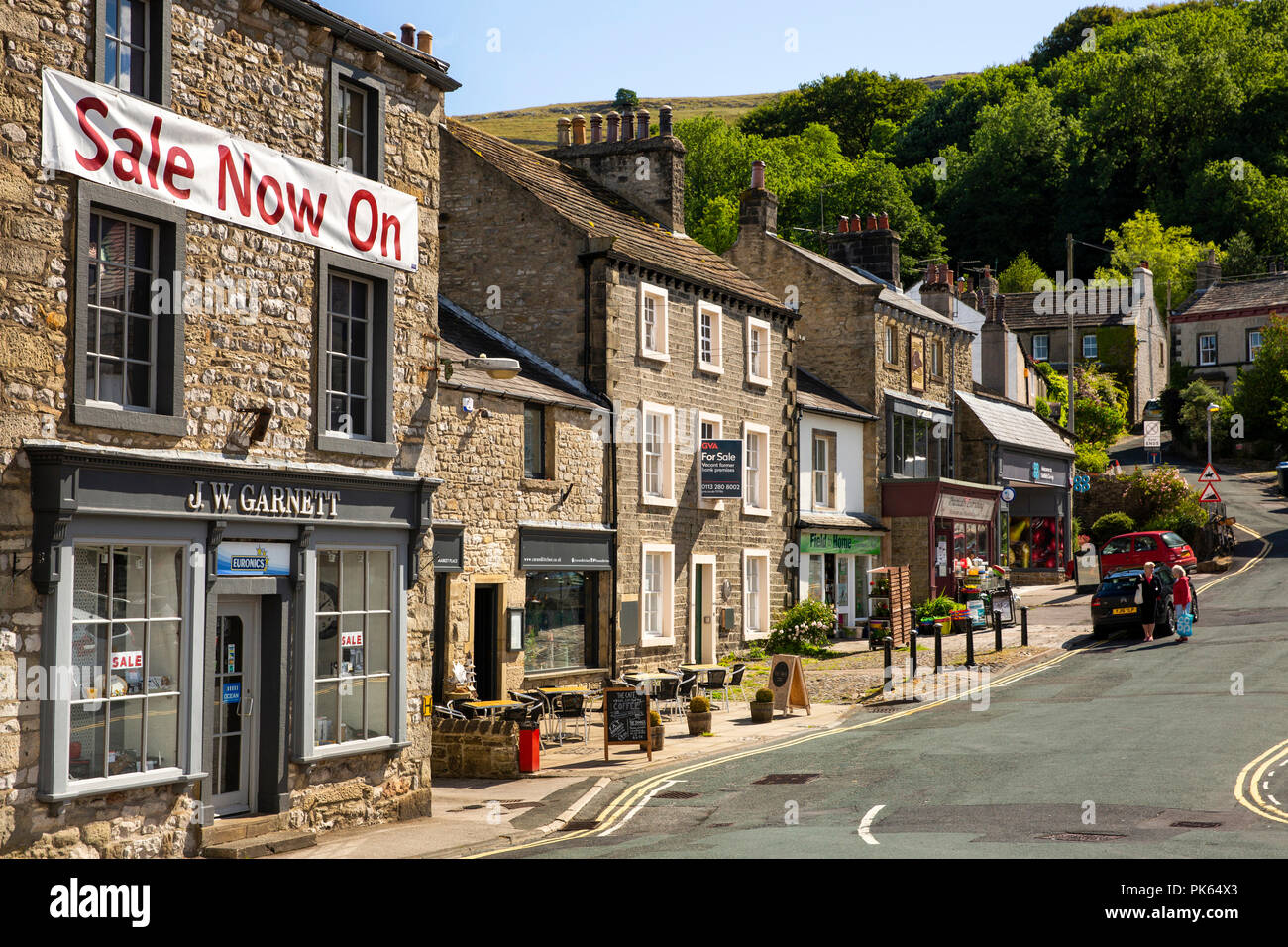 UK, Yorkshire, Settle, Market Place, shops beside road to Constitution ...