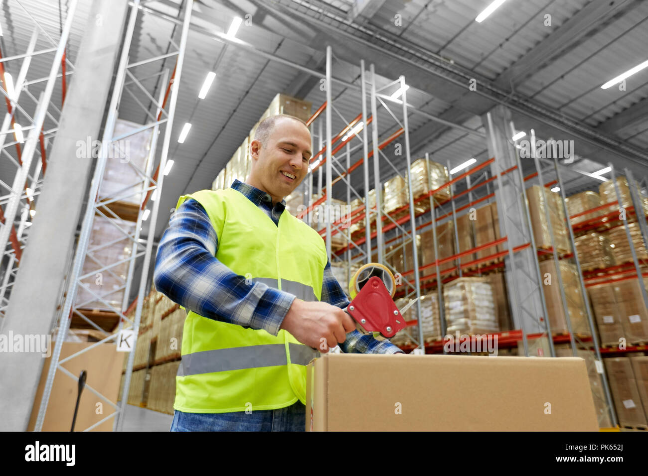warehouse worker packing parcel with scotch tape Stock Photo - Alamy
