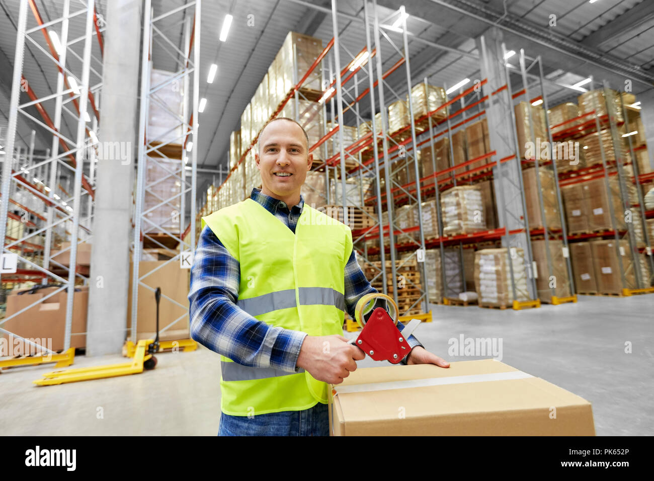warehouse worker packing parcel with scotch tape Stock Photo - Alamy