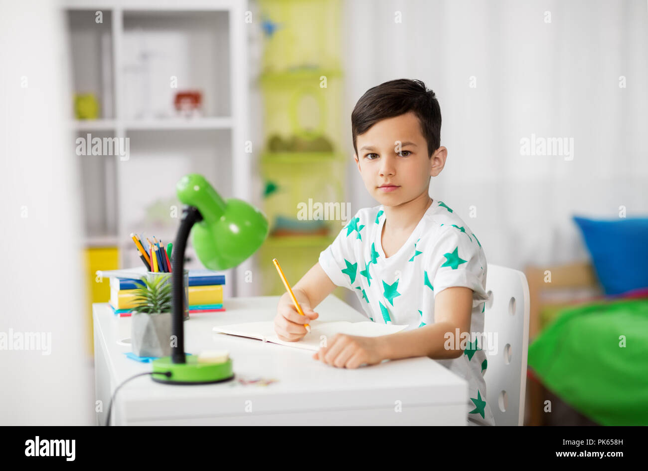 Boy writing diary hi-res stock photography and images - Alamy