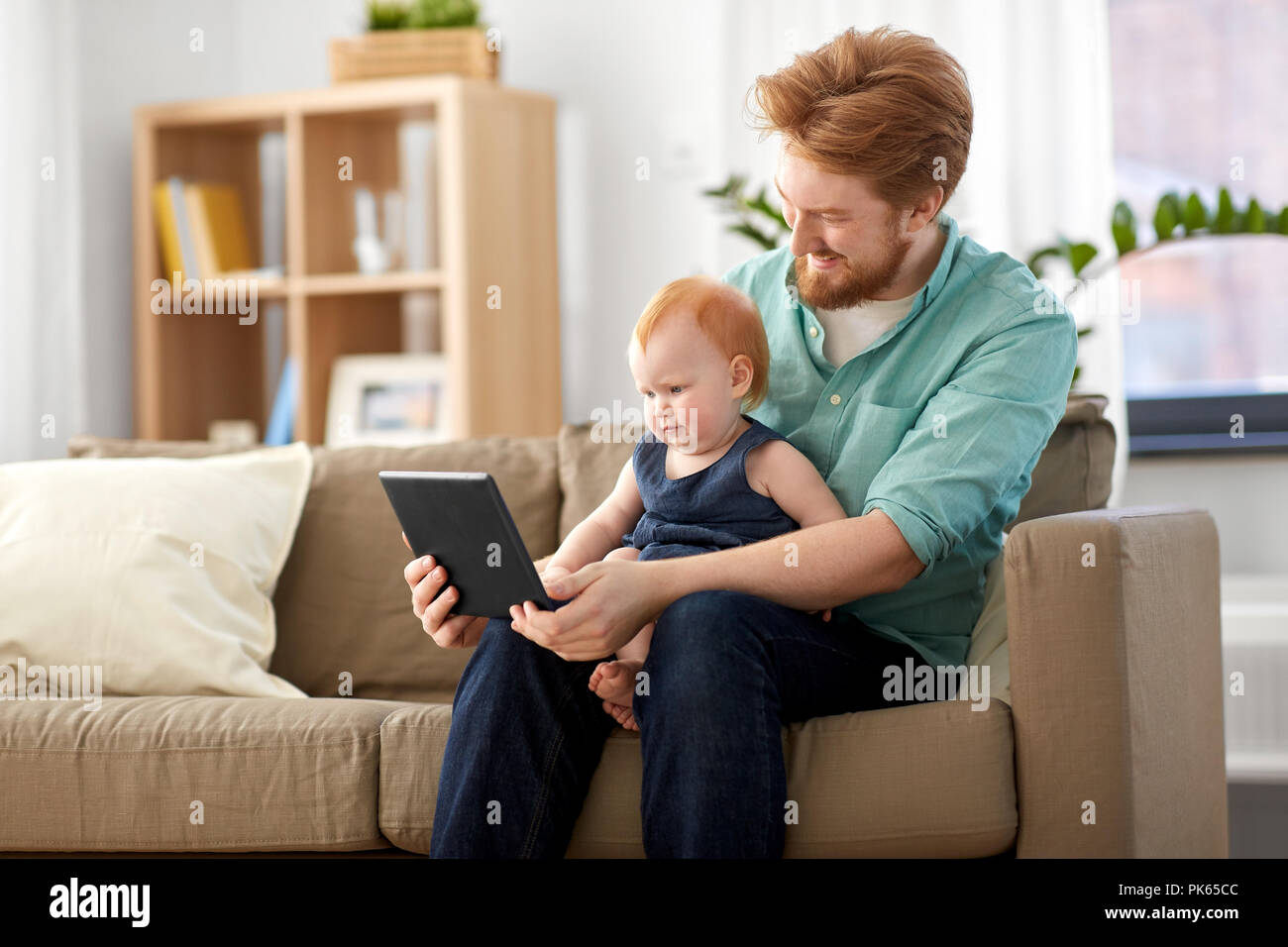 father and baby daughter with tablet pc at home Stock Photo - Alamy