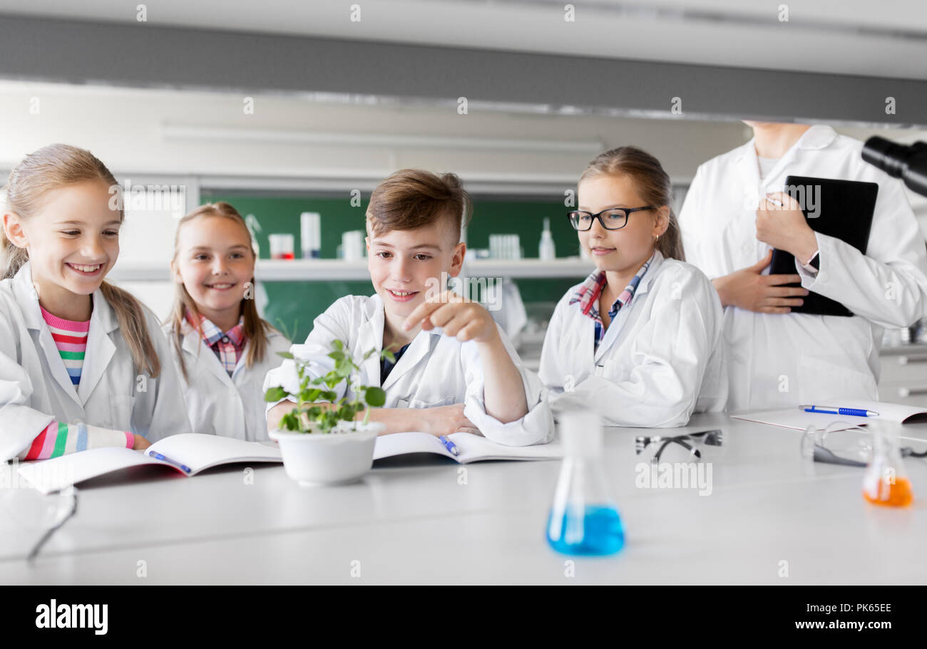 kids or students with plant at biology class Stock Photo - Alamy