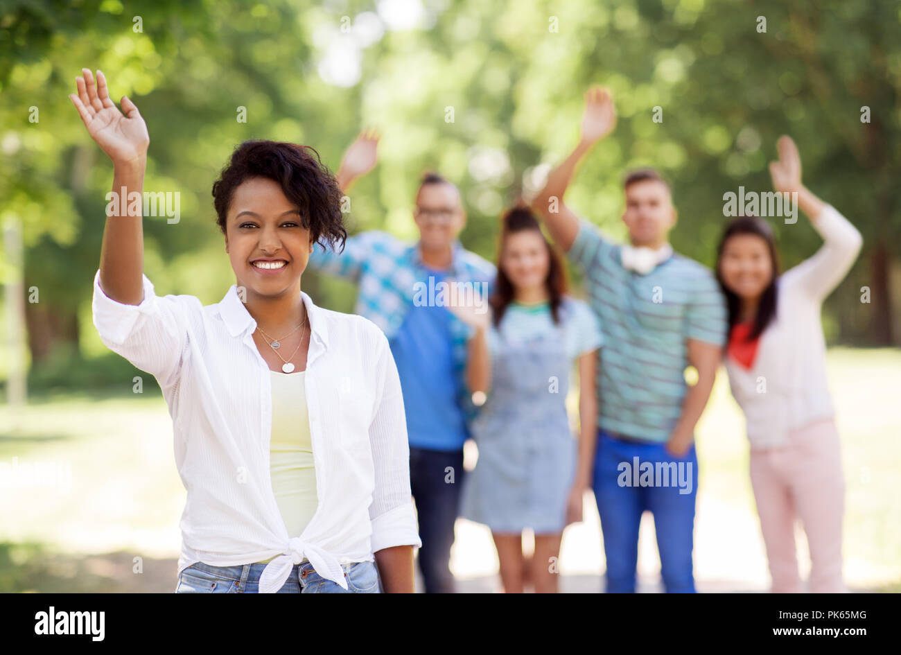 group of happy international friends waving hands Stock Photo - Alamy
