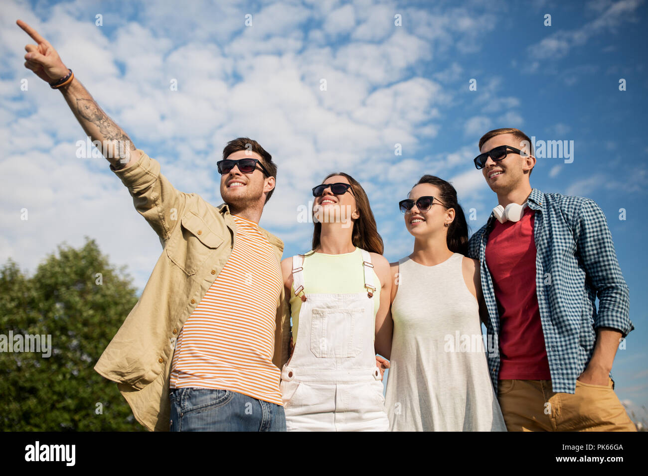 happy friends looking at something outdoors Stock Photo - Alamy