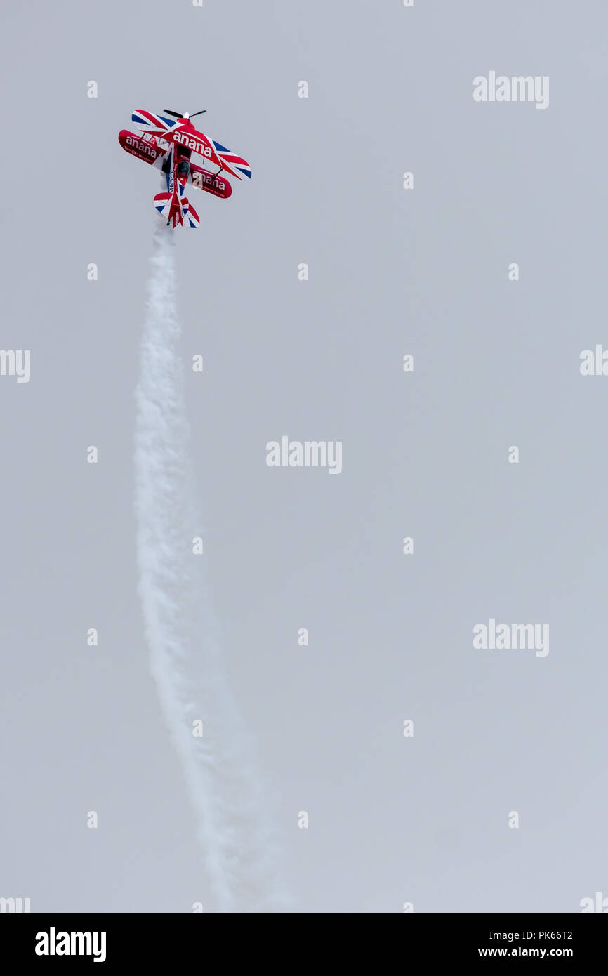 A Pitts Special S2S Biplane climbs high in the sky during its aerobatic ...