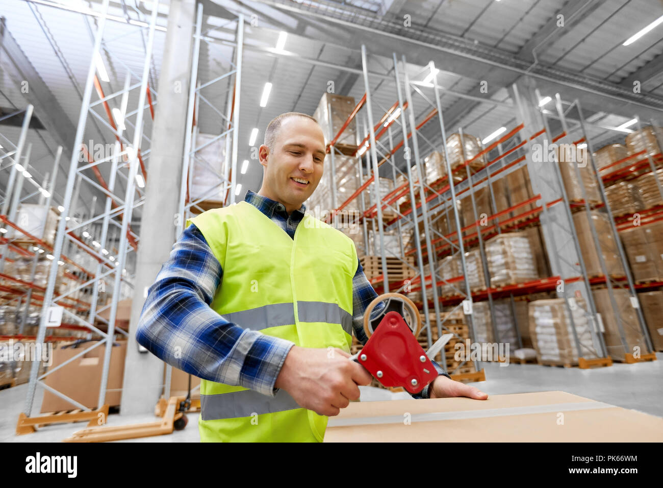 warehouse worker packing parcel with scotch tape Stock Photo - Alamy