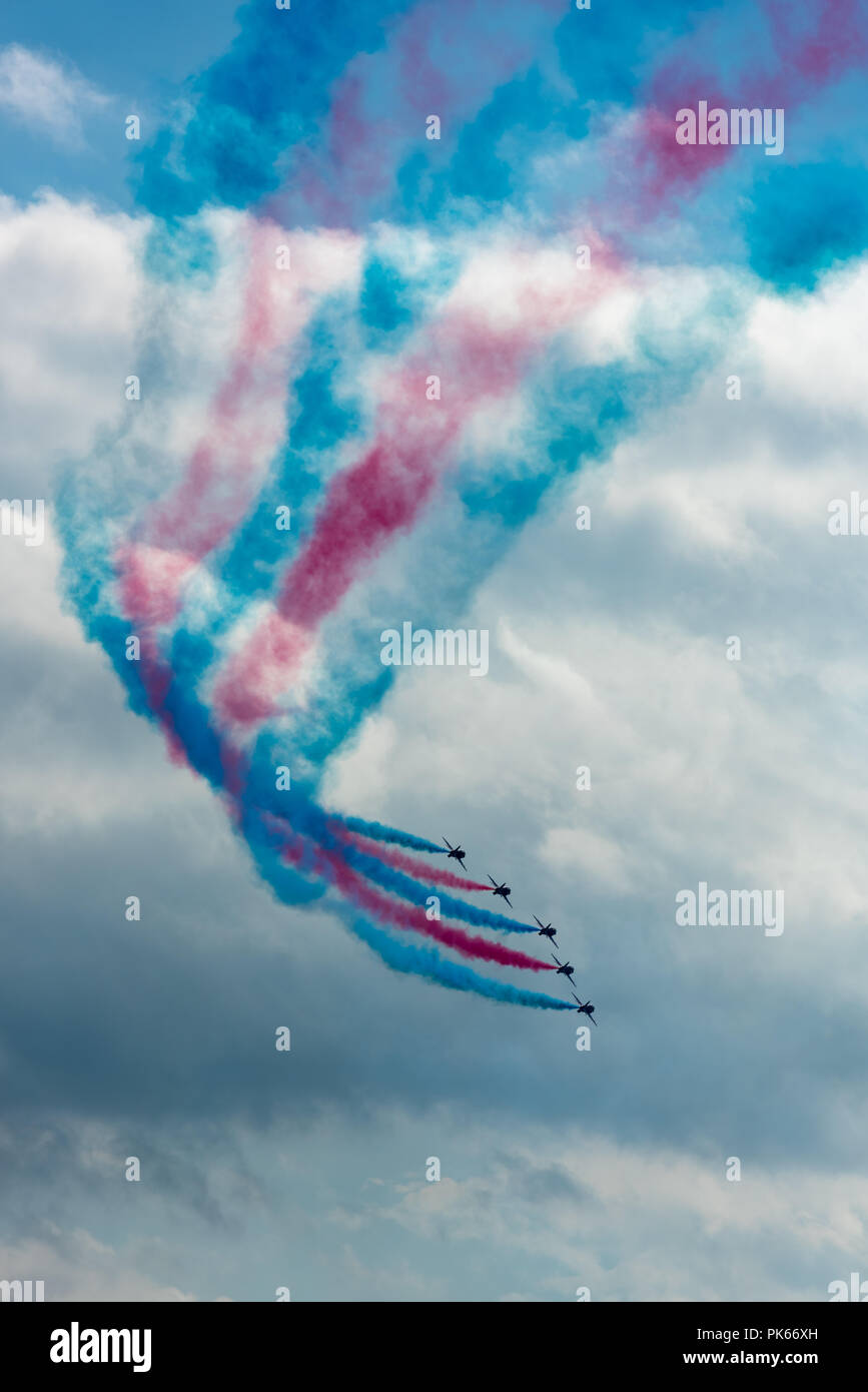Five Red Arrows Hawk jets trail their signature red and blue smoke ...