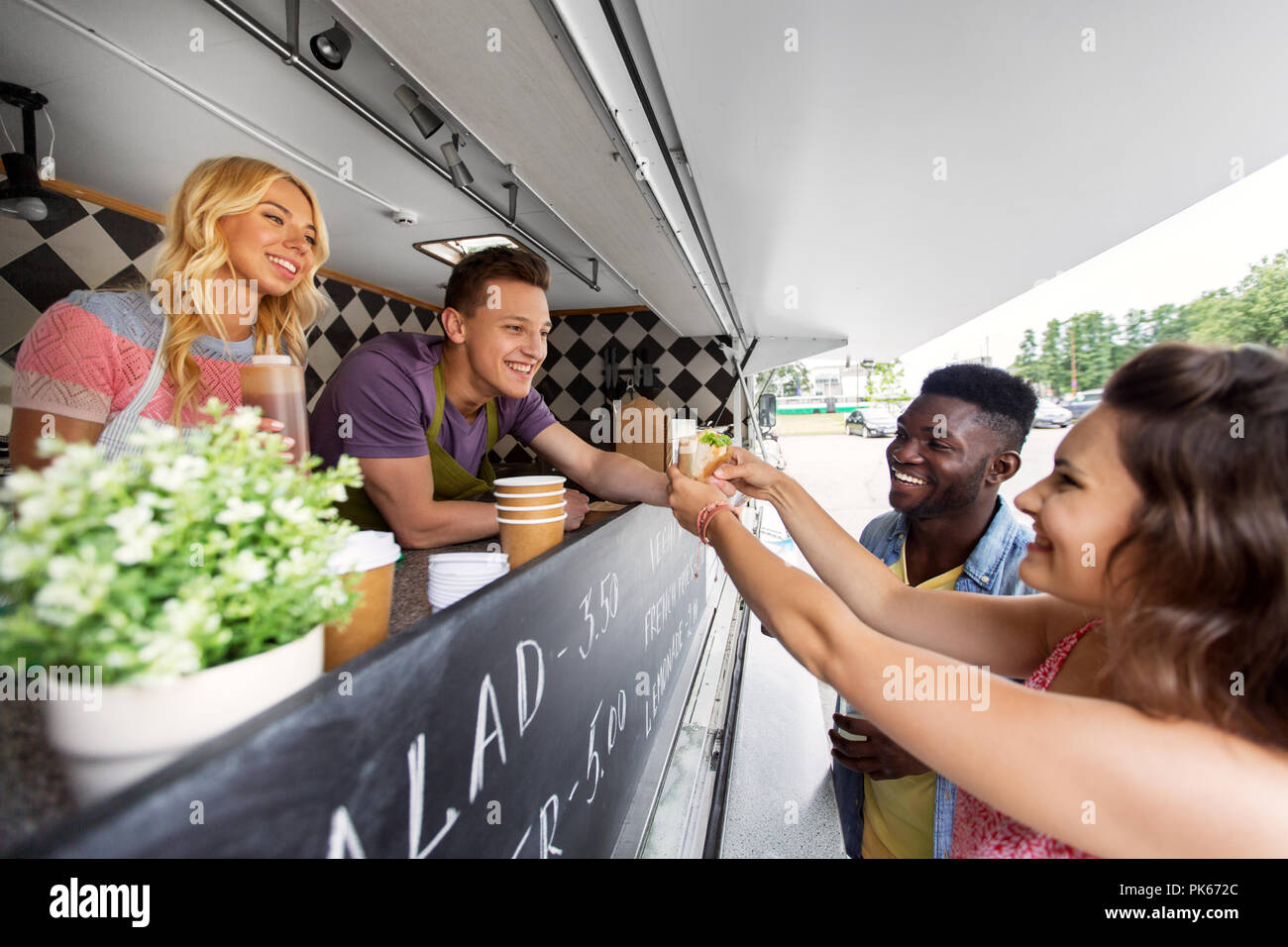 seller giving burger to customer at food truck Stock Photo - Alamy
