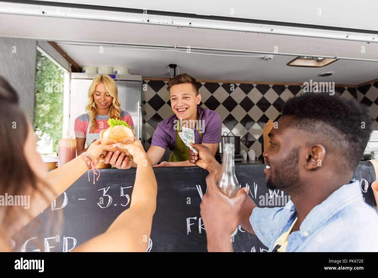 happy customers buying burger at food truck Stock Photo - Alamy