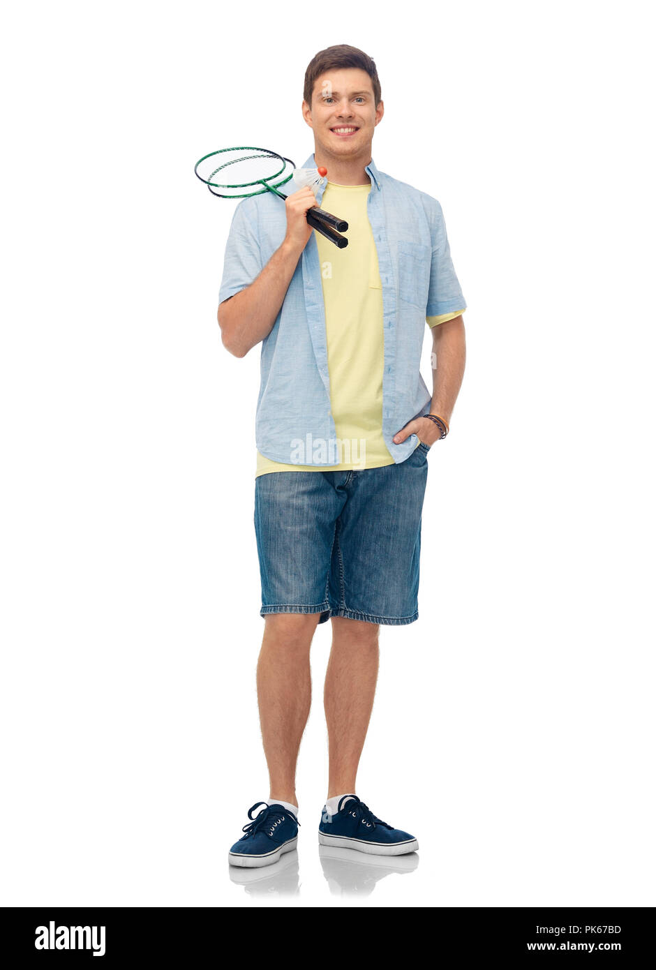 smiling young man with badminton rackets Stock Photo - Alamy