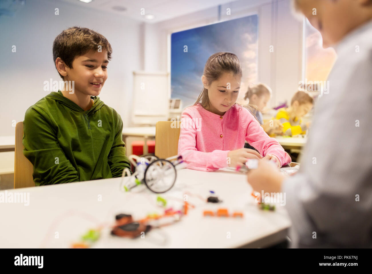 happy children building robots at robotics school Stock Photo - Alamy