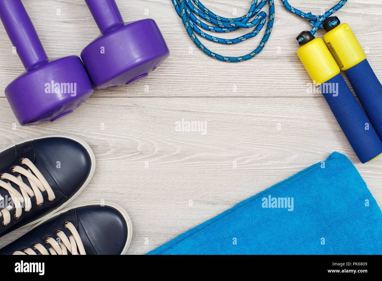 Different tools for fitness in room or gym on grey floor Stock Photo ...