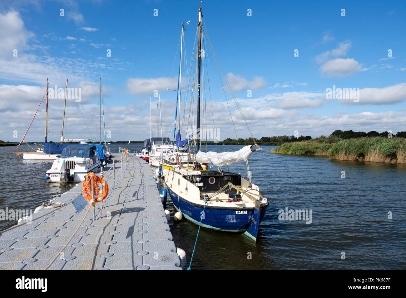 Boats moored on a temporary pontoon in Horsey Mere, Horsey Staithe ...