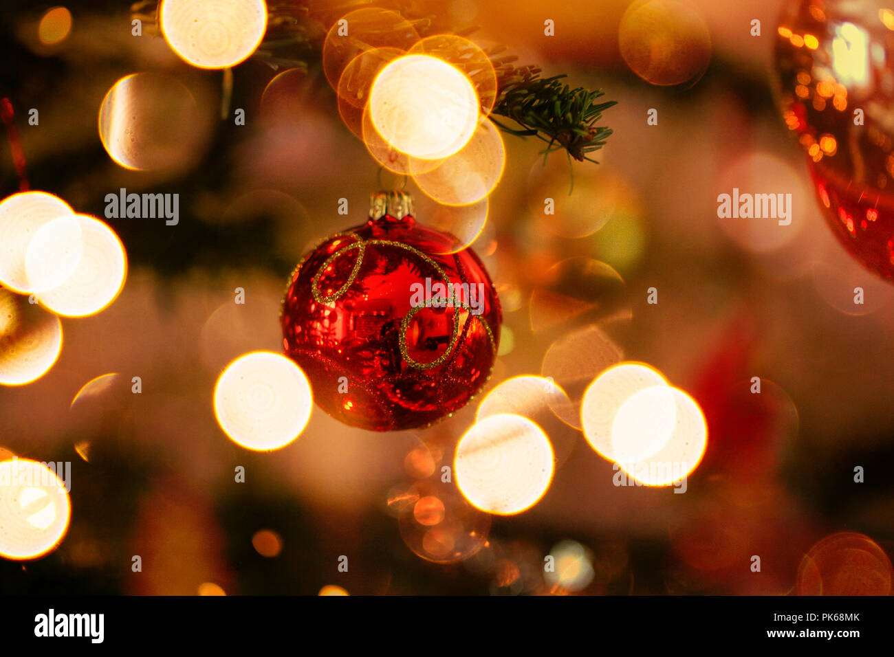 Holiday background with bauble, tree and lights Stock Photo - Alamy