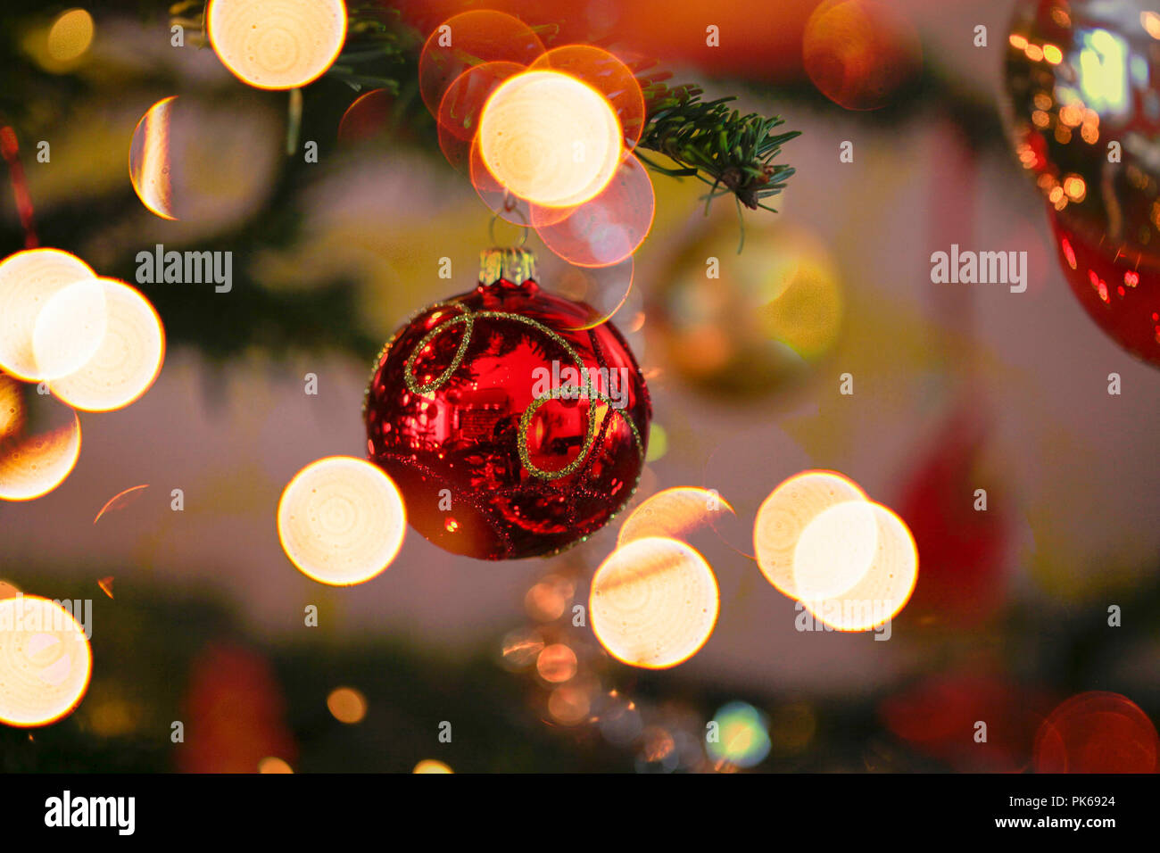 Holiday background with bauble, tree and lights Stock Photo - Alamy