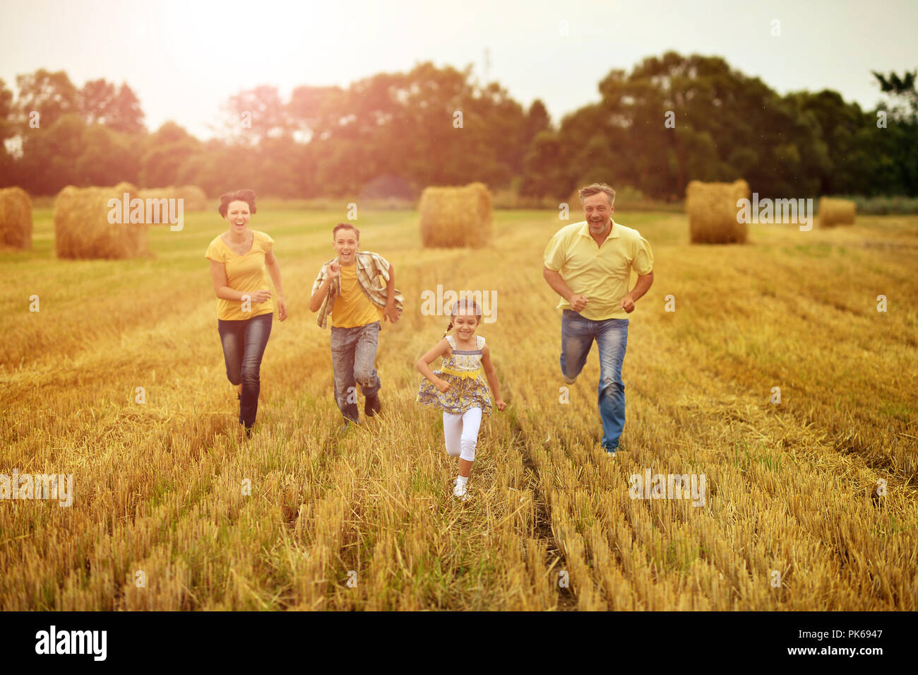 Happy family running hi-res stock photography and images - Alamy