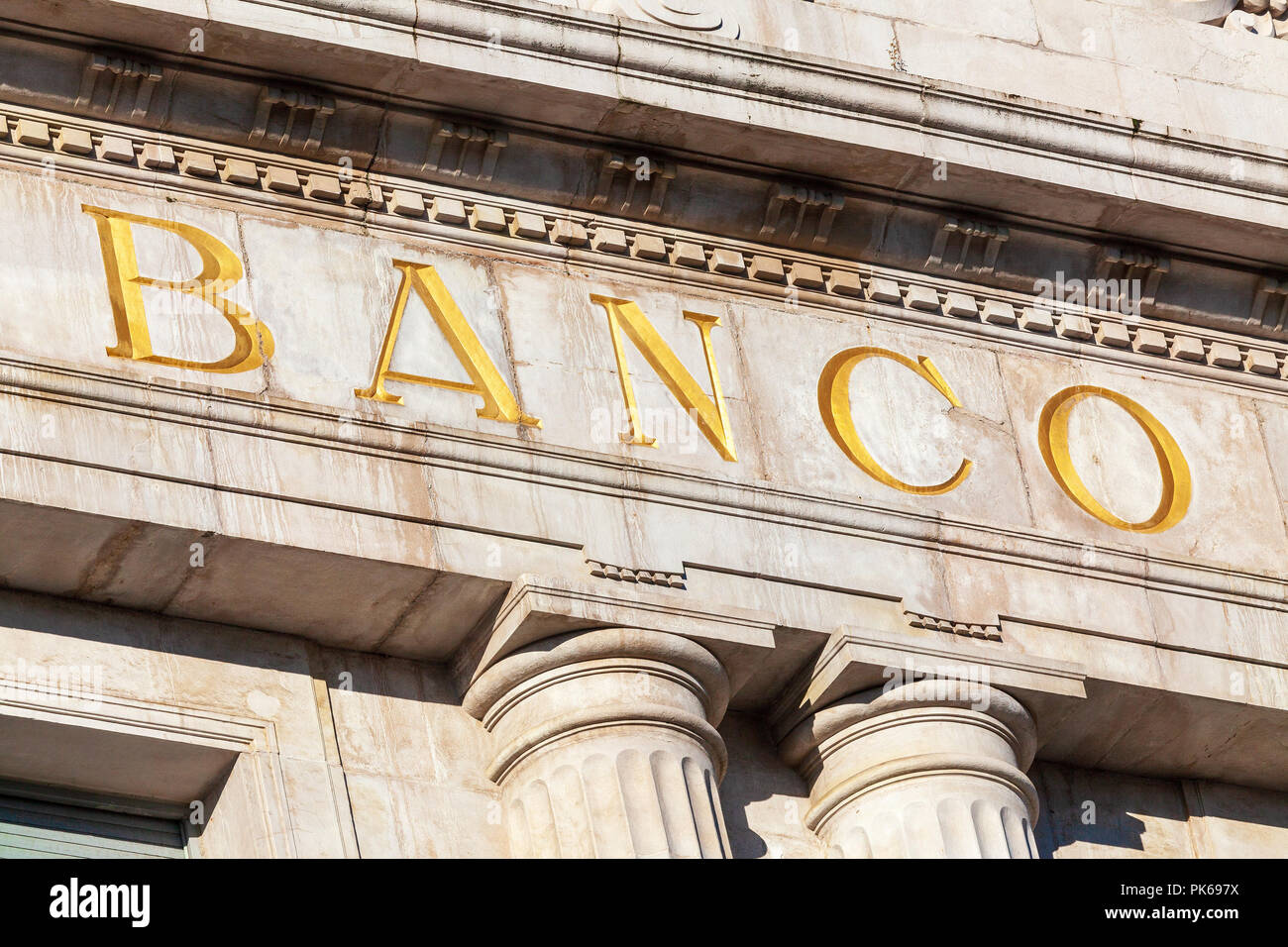 Word bank in Spanish sculpted in stone and golden color Stock Photo - Alamy