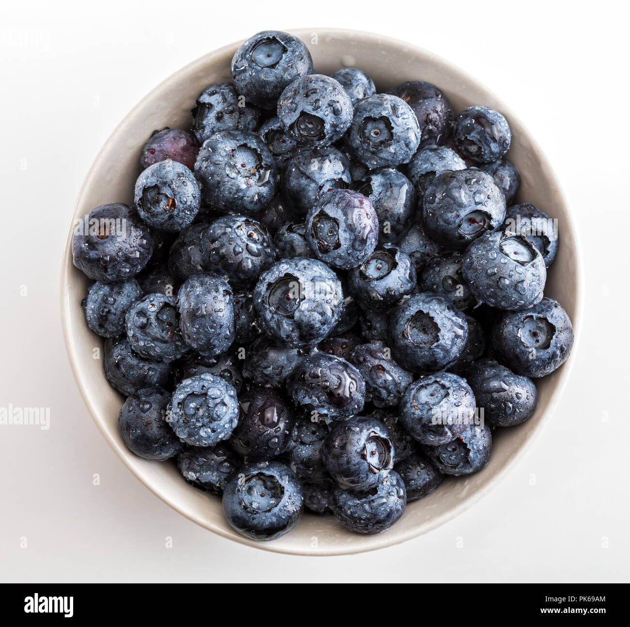 Fresh and raw blueberries in delicate white porcelain bowl. Isolated ...