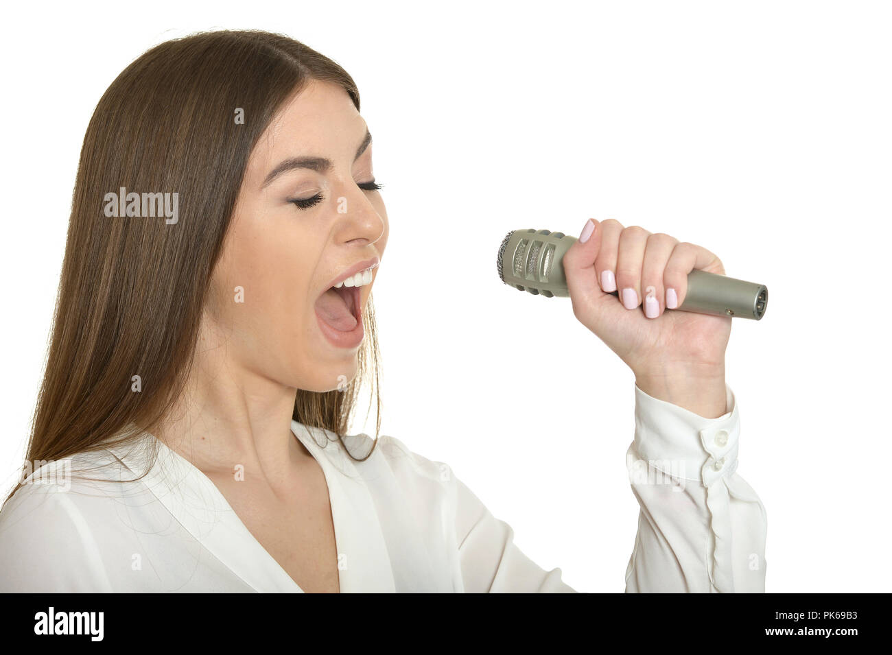 Young woman with microphone on white background Stock Photo - Alamy