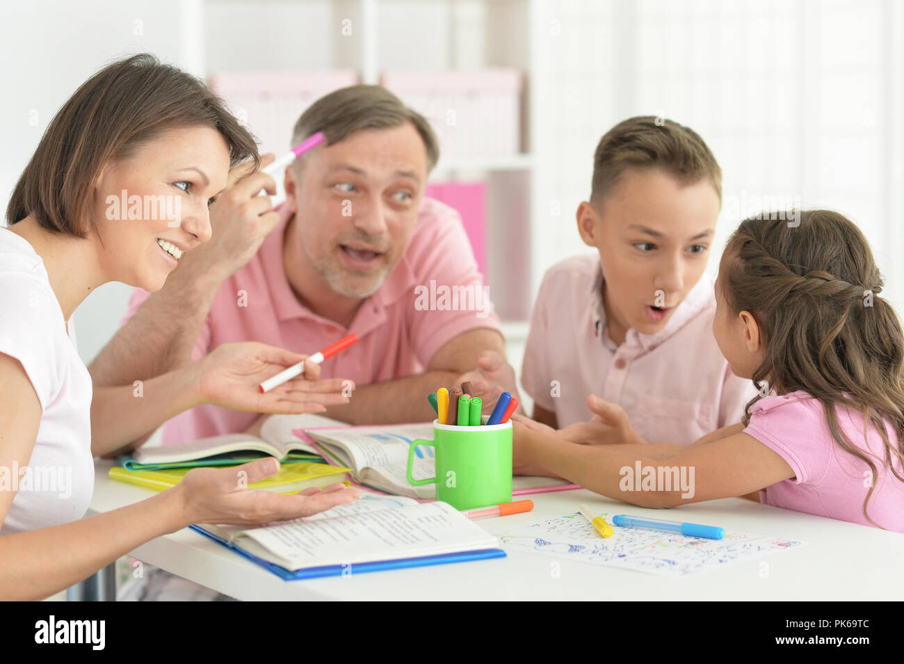 Big happy family doing homework at home Stock Photo - Alamy