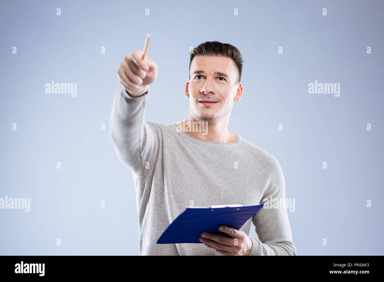 Serious smart man pointing with a pencil Stock Photo - Alamy