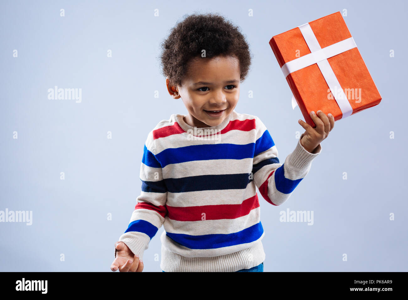 Happy delighted boy receiving a nice present Stock Photo - Alamy