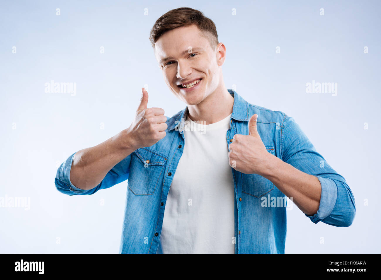 Happy positive nice man achieving his success Stock Photo - Alamy