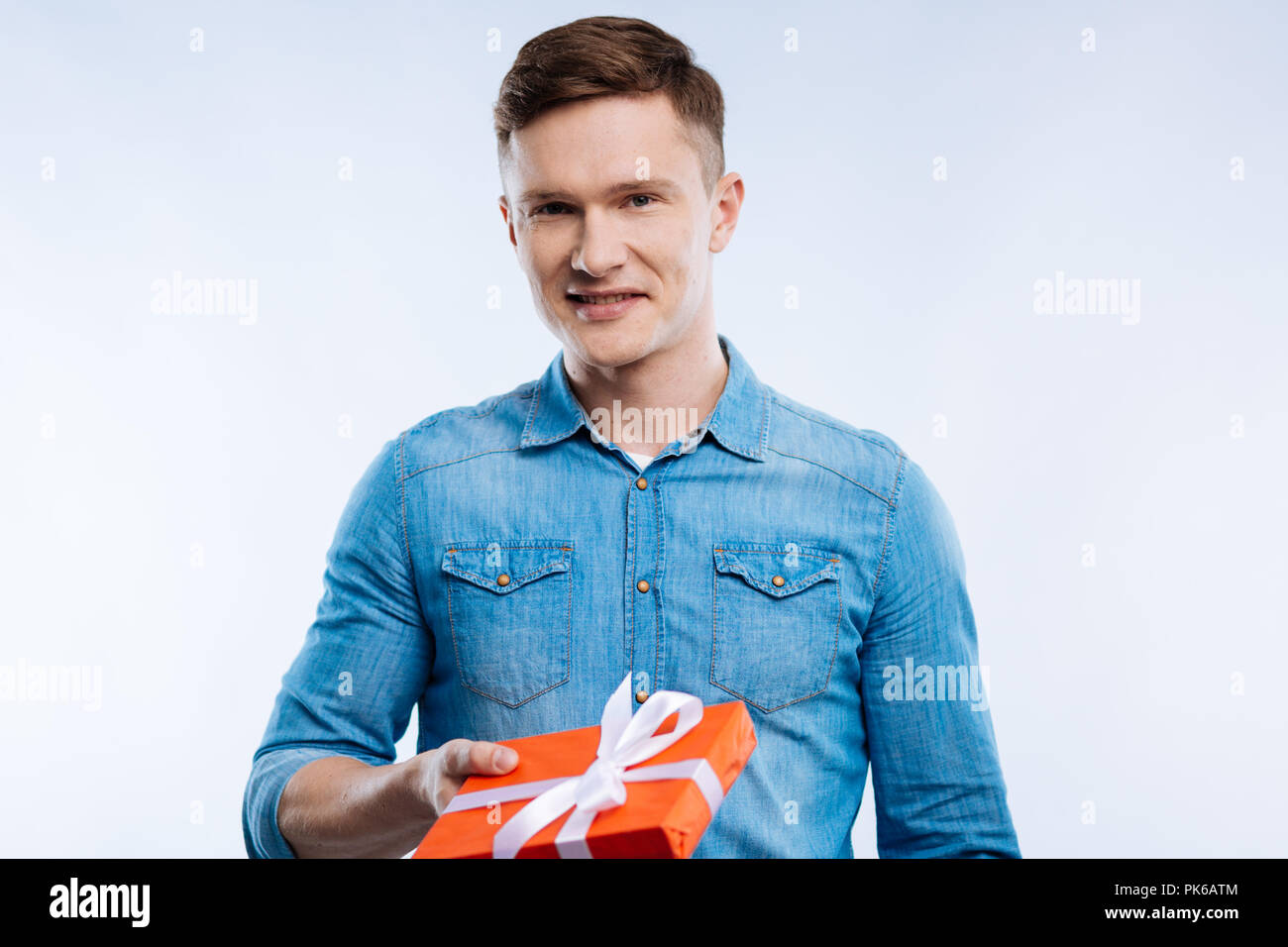 Happy handsome man giving you a present Stock Photo - Alamy