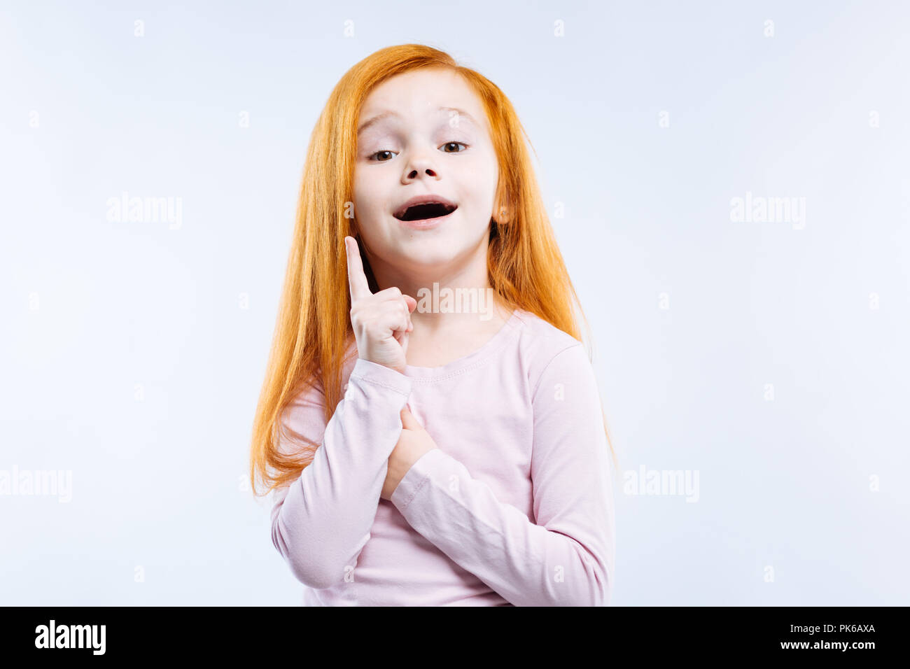 Nice smart cute girl having an idea Stock Photo - Alamy