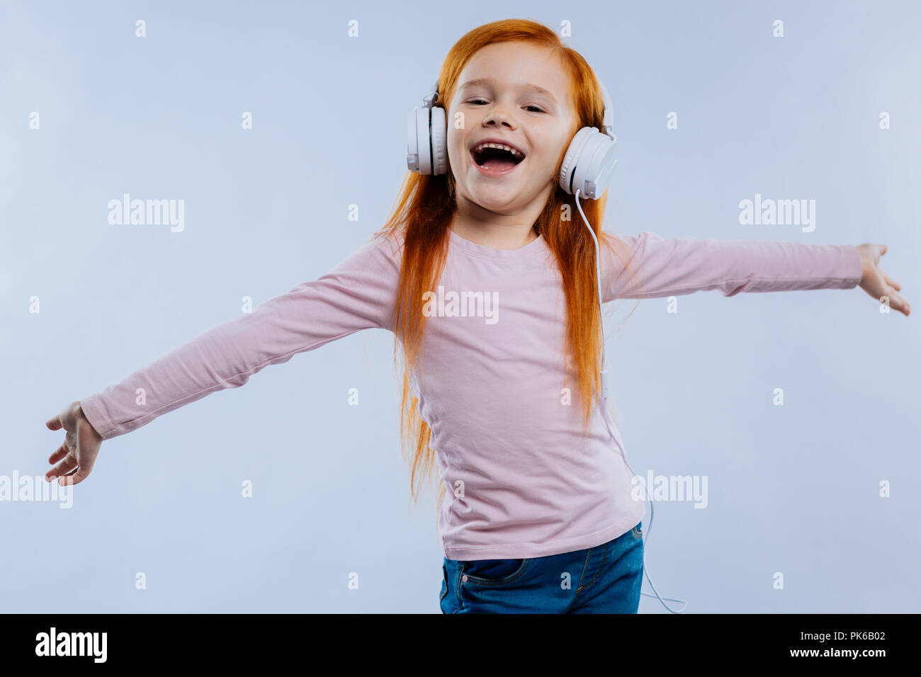 Happy girl headphones singing hi-res stock photography and images - Alamy