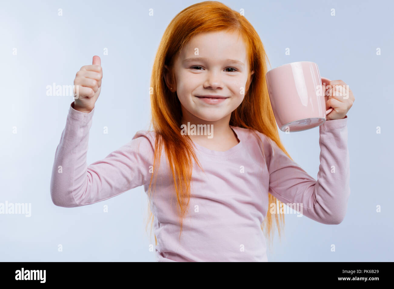 Cheerful positive girl showing you OK sign Stock Photo - Alamy