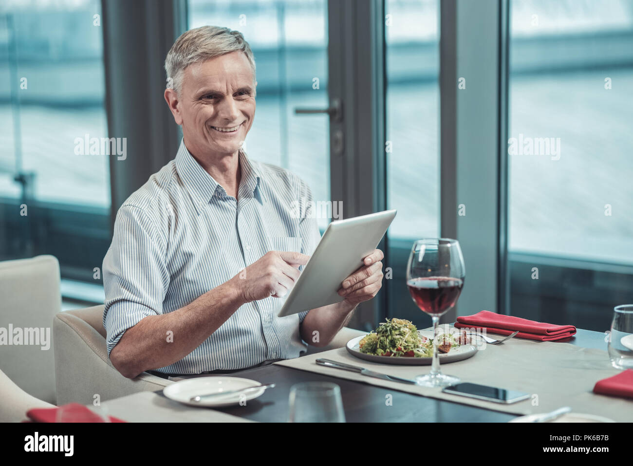 Happy smiling pensioner spending lunch in cafe Stock Photo - Alamy