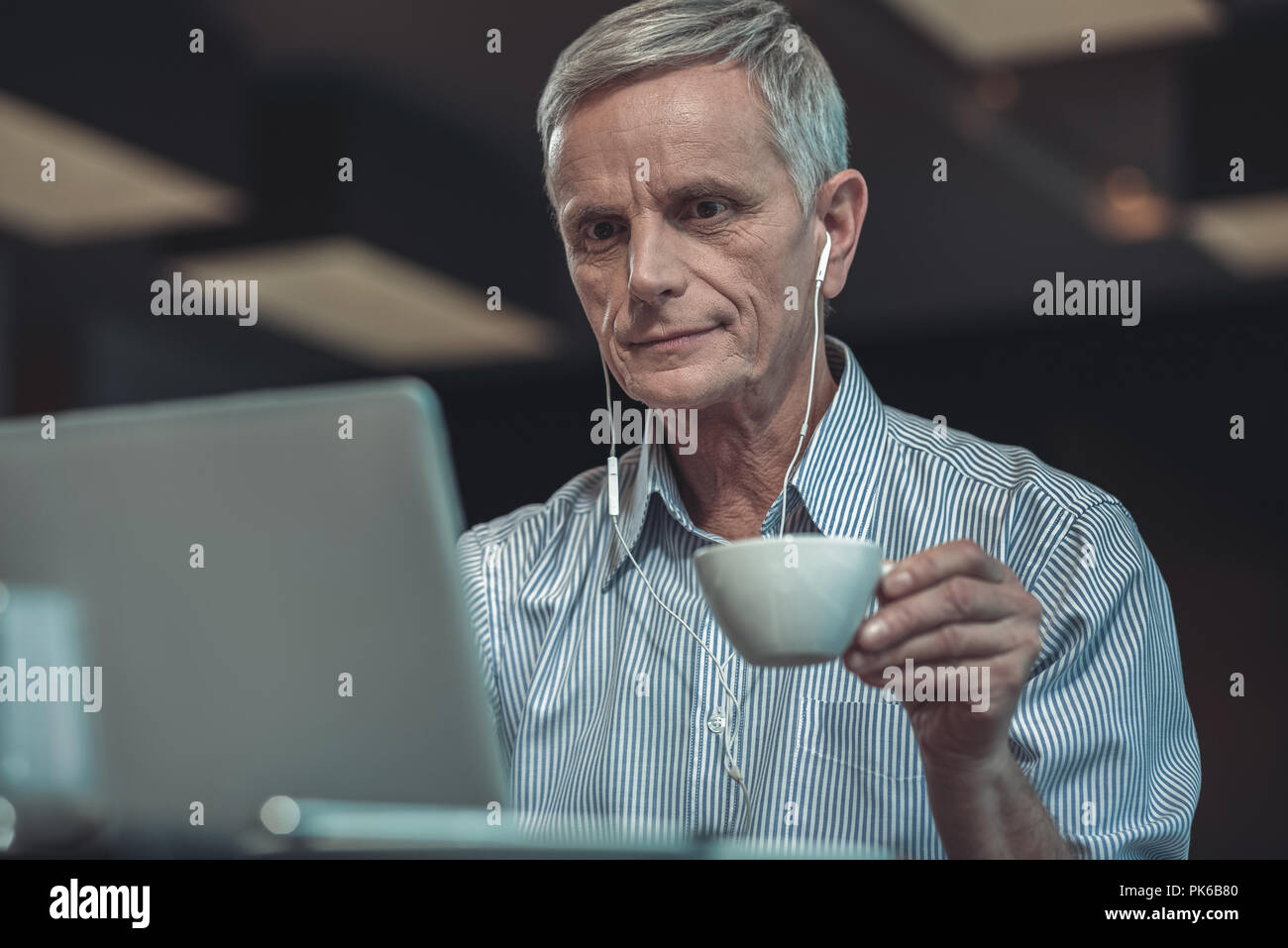 Concentrated mature man watching video in the internet Stock Photo - Alamy