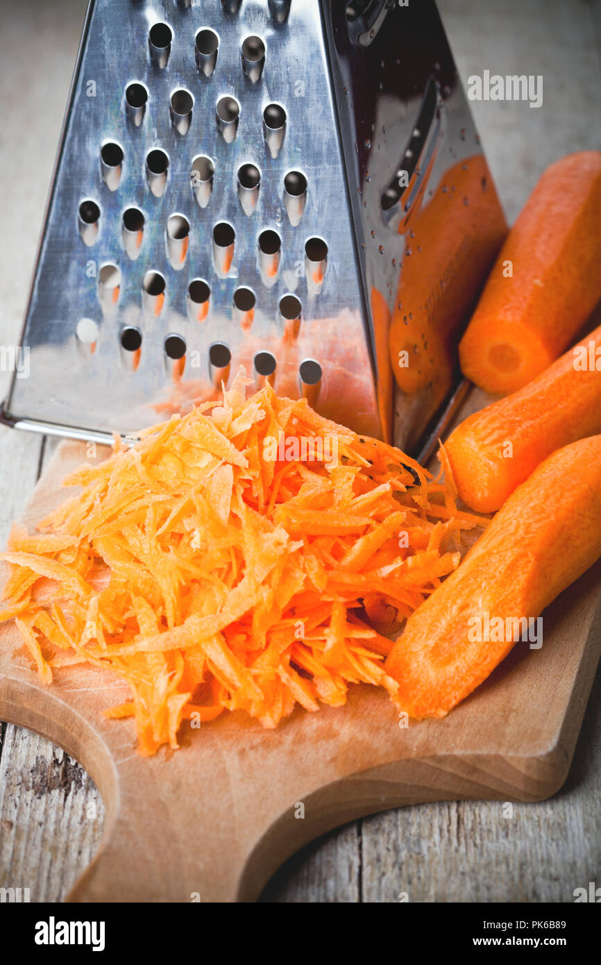 metal grater and carrot closeup on cutting board Stock Photo - Alamy