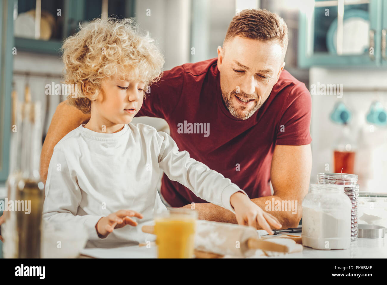 Bearded father helping his cute boy forming biscuits Stock Photo - Alamy